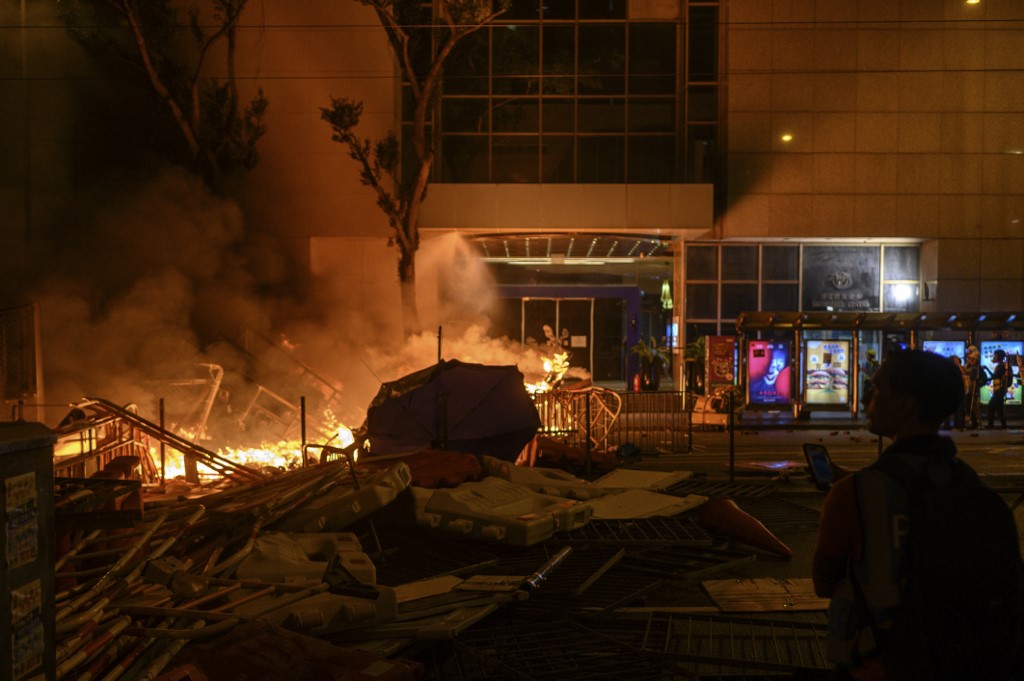 Associated Press: Hong Kong protesters build wall, set fire on a main ...